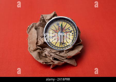 Compass on wrapped paper on red Stock Photo - Alamy