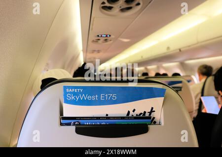 Embraer E175 airplane safety manual in plane seat pocket in front of ...