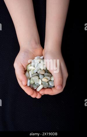 Handful of clean pebbles, gravels in hands Stock Photo - Alamy