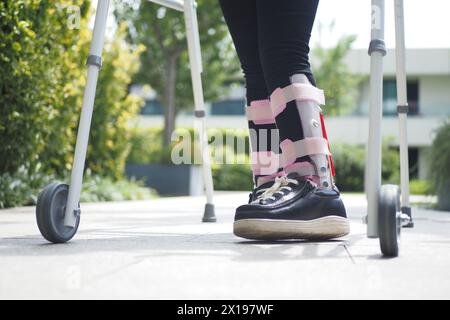 child with walking frame and knee orthosis outdoor Stock Photo - Alamy