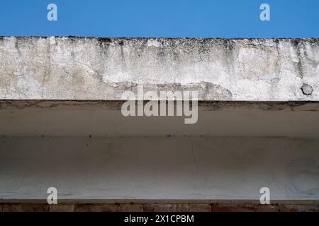 facade with building cornice with infiltration and erosion of the ...