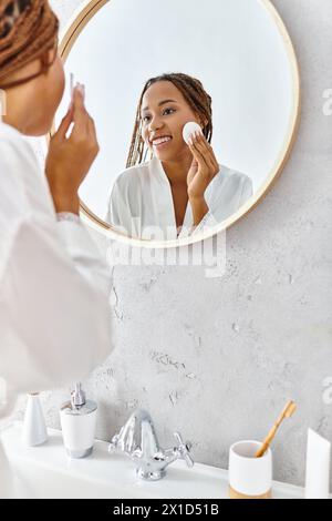 African american woman with braids using laptop at home amazed and ...