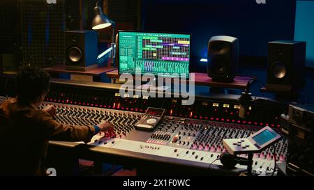 African american audio expert adding sound effects on tracks in post ...