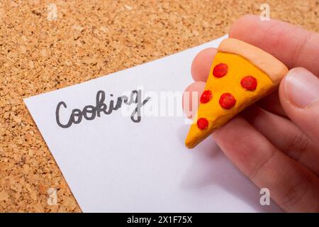 Piece of pizza model and cooking word. Cooking concept Stock Photo - Alamy