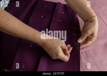 Latin American seamstress inserts sewing pins Stock Photo - Alamy