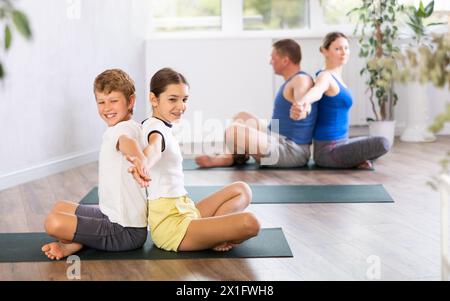 Happy sister and brother practicing yoga poses Stock Photo - Alamy