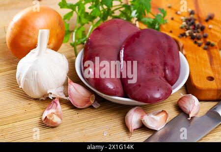 Fresh raw pork kidneys with seasonings on wooden background. Home ...