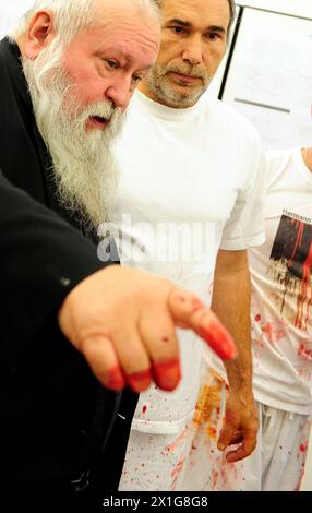 Austrian artist Hermann Nitsch paints with food and blood during an art ...