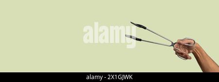 Male hand holding kitchen tong isolated white background Stock Photo ...