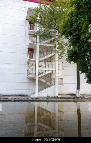 Close-up of reciprocating stairs hanging on the exterior wall of a ...