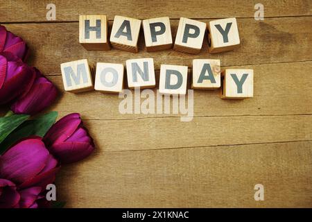 Monday wooden letter alphabet with tulip flower on yellow background ...