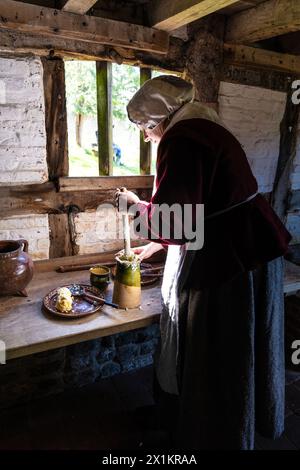 Woman churning butter in a medieval cottage, Weald & Downland Living ...