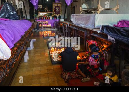 Mayan indigenous people pray and burn candles on altar platforms inside ...