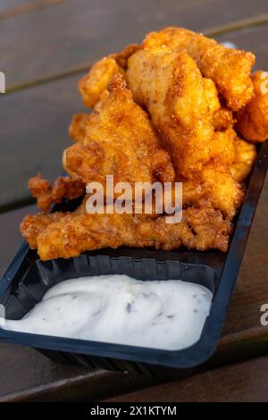 Seafood, outdoor eating of diep-fried cod fish pieces served with ...