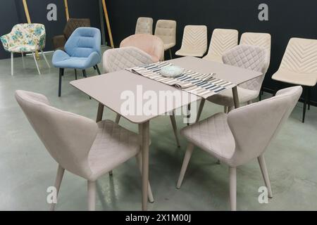 Beige wooden table complete with beige chairs with soft fabric ...