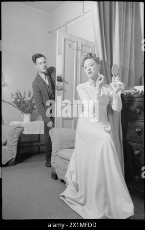 Backstage at the Lyric Theatre, Shaftesbury Avenue, Binnie Hale assists ...