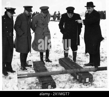 Prime Minister Winston Churchill observes a landing craft launching a ...