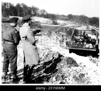 His Majesty the King observes a bulldozer at work during a visit to ...