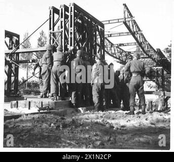 Soldiers of the 49th Division, 1st Corps, B.L.A., inspect the bridge ...