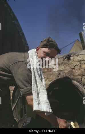 Private W A Bowen of the Army Catering Corps prepares potatoes at ...