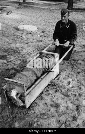 Corporal Karl Greise, German guard at Stalag Luft III, demonstrates an ...