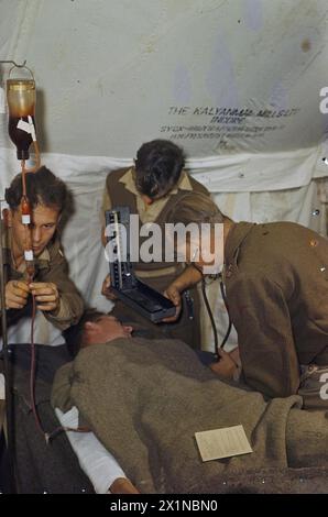A leg-wounded patient receives a blood transfusion and plaster bandage ...