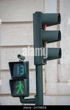 Green traffic light for pedestrians counting down in 13 seconds in ...