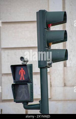 a city crossing with a semaphore on blurred background with cars in the ...