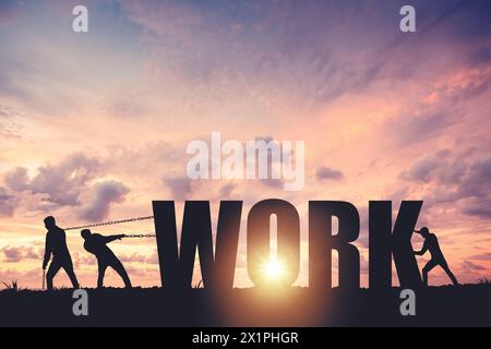 Silhouettes of people drawing the word WORK on a sunset background ...