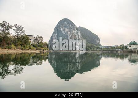 Two beautiful limestone mountains surrounded by the river and village ...