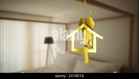 A golden house-shaped keychain hanging in focus with blurred bedroom background Stock Photo - Alamy