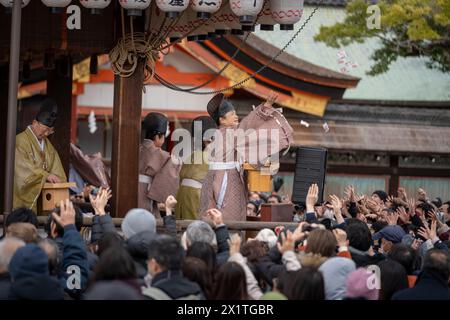 Yasaka Shrine Setsubun festival roasted beans scattering ceremony "mamemaki". Maiko throwing the ...