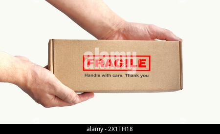 One rectangular cardboard box in hands for fragile items packing on a ...