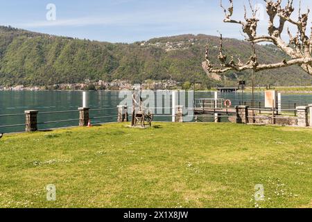 Lakefront in Bissone with the bronze sculpture depicting a fisherman ...