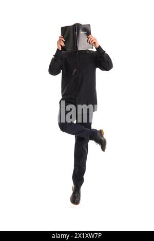 Young priest with Holy Bible jumping on white background Stock Photo ...
