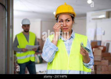 Woman builder crying because of low wages Stock Photo - Alamy