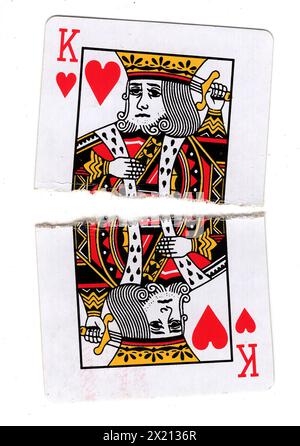 A king of spades playing card torn in half on a white background Stock ...