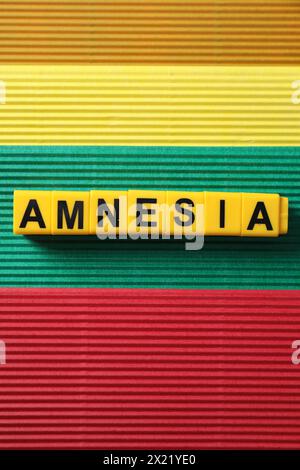 Yellow cubes with word Amnesia and human head cutout with drawing of ...