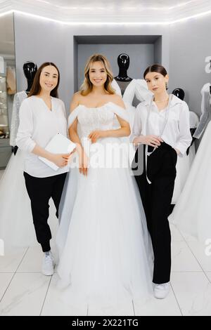 The bride-to-be chooses a dress for the wedding. A dressmaker's ...