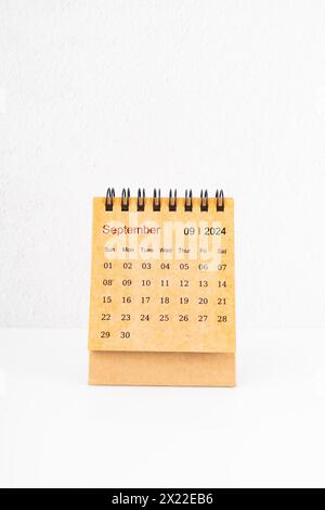 Brown mini desk calendar for September 2025 isolated on white ...