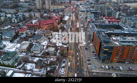 Drone photography of main street going through city covered by snow ...