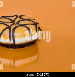 Toffee filled doughnut on toffee coloured background Stock Photo - Alamy