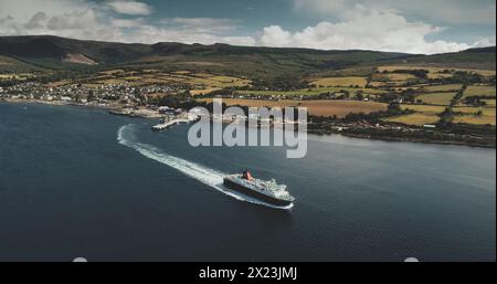 Scotland, Brodick Ferry Terminus aerial panoramic shot of ship crossing ...