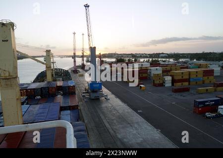 Container ship equipped with ship cranes during cargo operation loading ...