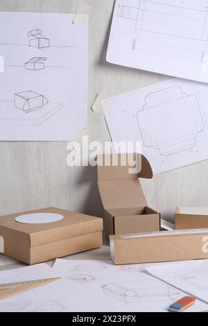 Creating packaging design. Drawings, boxes and stationery on light ...