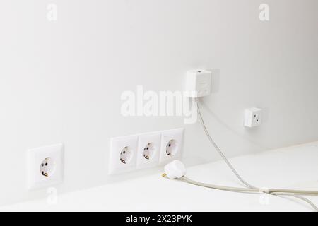 A power cord cable is disconnected from a group of white European ...