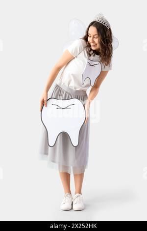 Tooth Fairy with paper figure on light background Stock Photo - Alamy