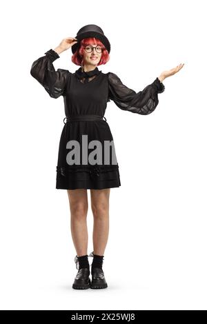 Female magician with a top hat performing a magic trick with a card ...