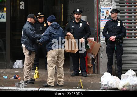 Police officers and the NYPD crime scene unit collect evidence. Man ...