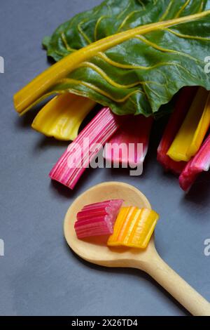 Red and yellow chard, wooden spoon and chopped stems, Beta vulgaris ...